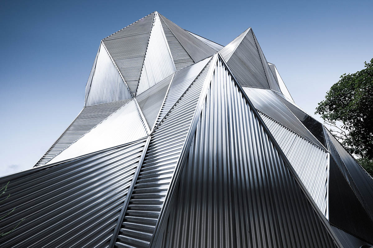 Angular corrugated stainless steel sheets form this showroom designed ...