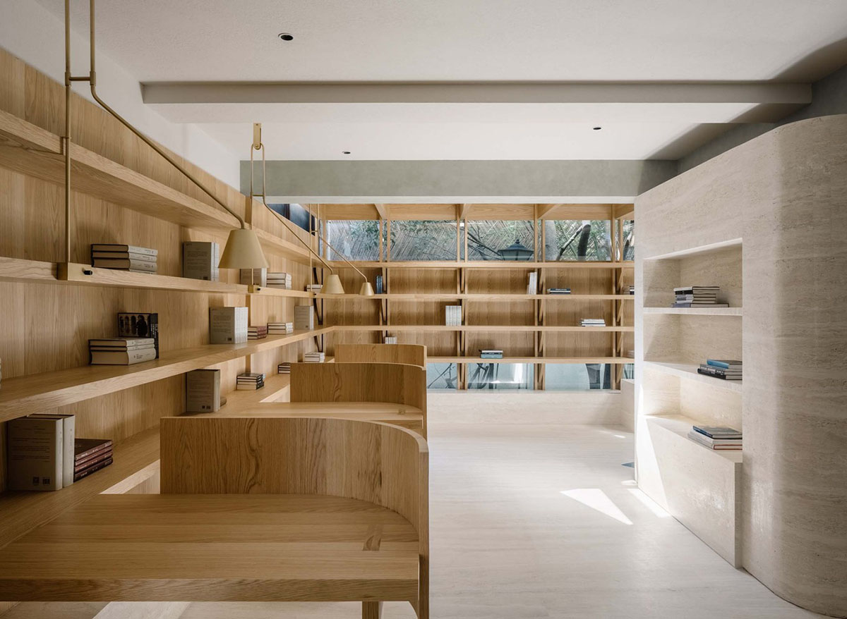 Atelier tao+c creates reading room with semi-circular bookshelves and ...
