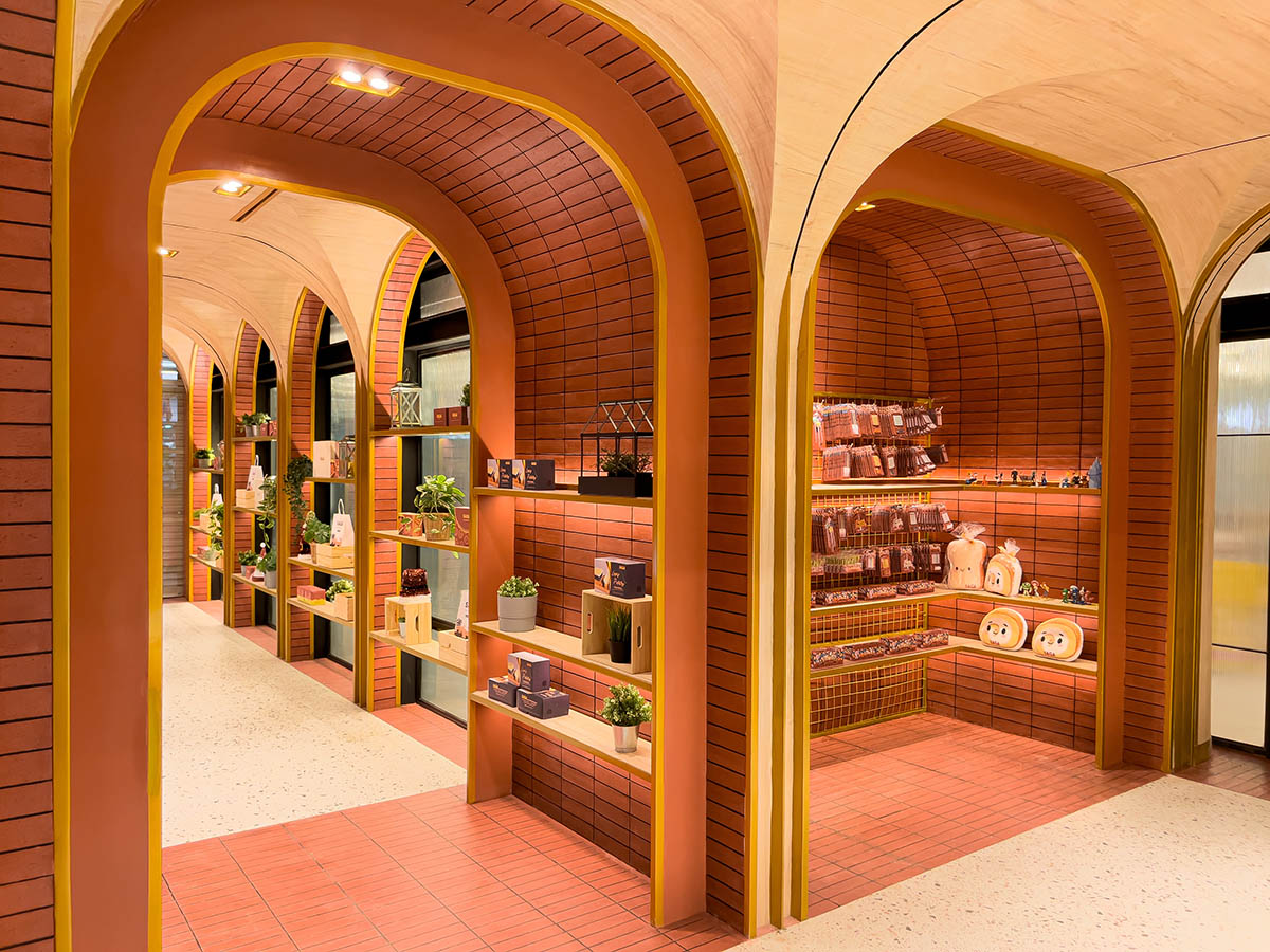 Bakery interior mimics arches and portals with bright red bricks in ...