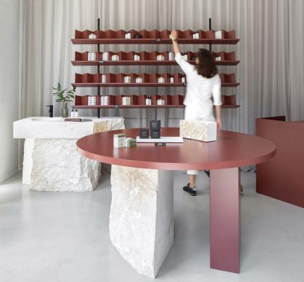 Studio AUTORI uses marble display counters and red shelves for ...