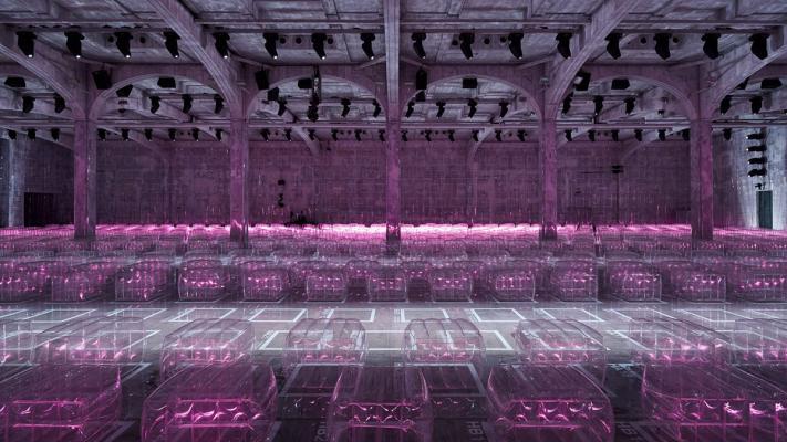 AMO filled Prada's fashion show stage with purple-lit inflatable stools