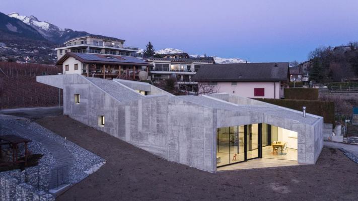 Anako Architecture completes slopped concrete residence in Switzerland